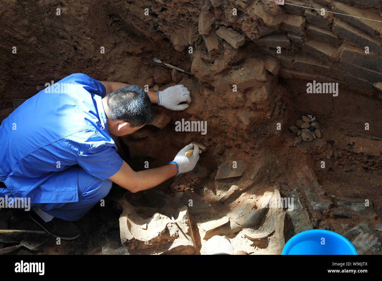 A Chinese archaeologist excavates in the No.1 Pit at the Museum of the ...