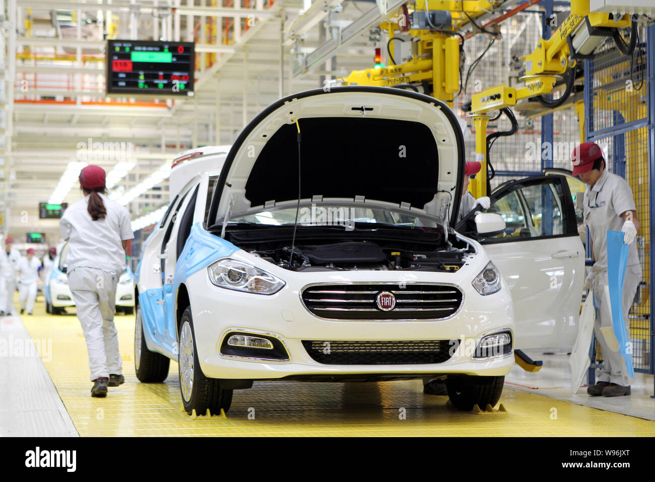 Chinese workers assemble Fiat Viaggio cars on the assembly line at the ...