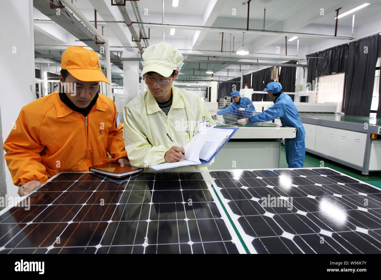 --FILE--Chinese factory workers manufacture solar panels to be exported ...