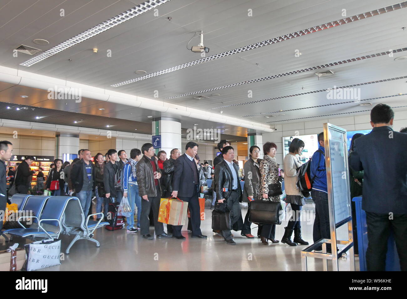 Passengers are pictured as they await for departure at Harbin Taiping ...