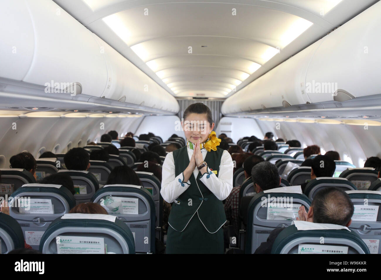 A cabin crew member is pictured as she teaches passengers perform ...