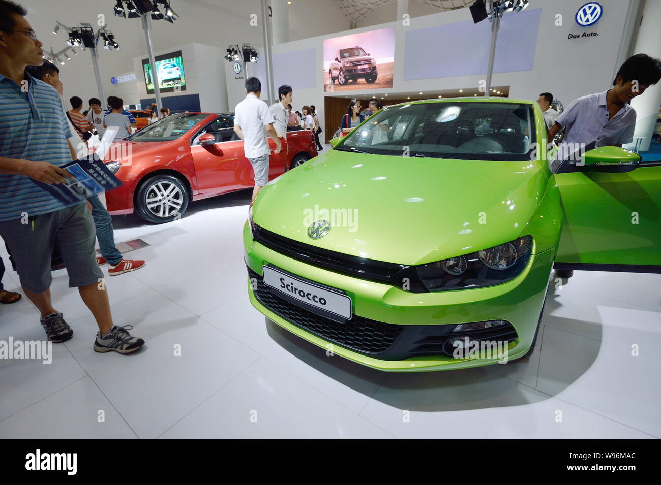 --FILE--Visitors look at a Scirocco and other Volkswagen cars during an ...