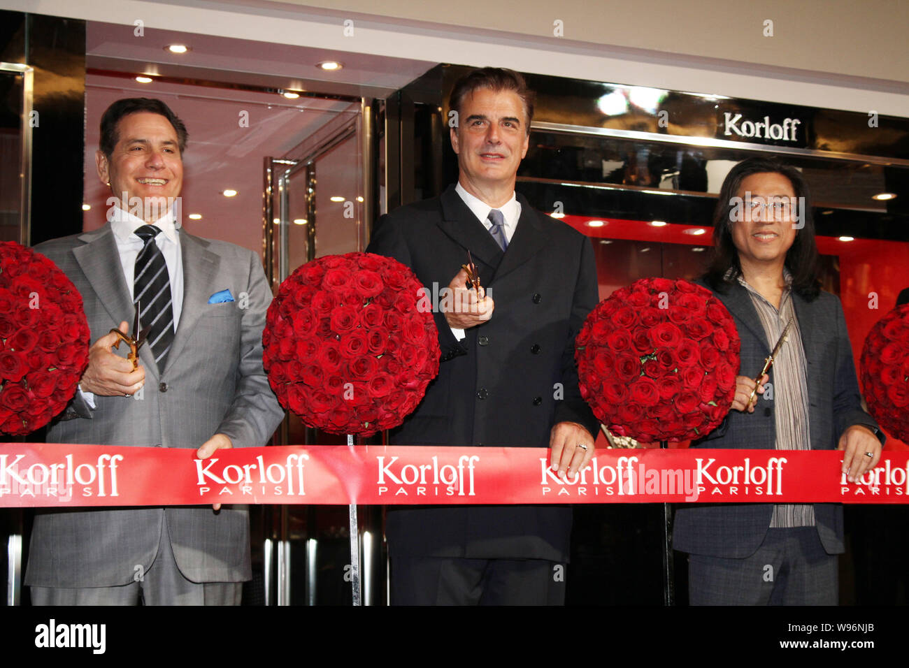 American actor Chris Noth (C) poses with other guests before he cuts ...