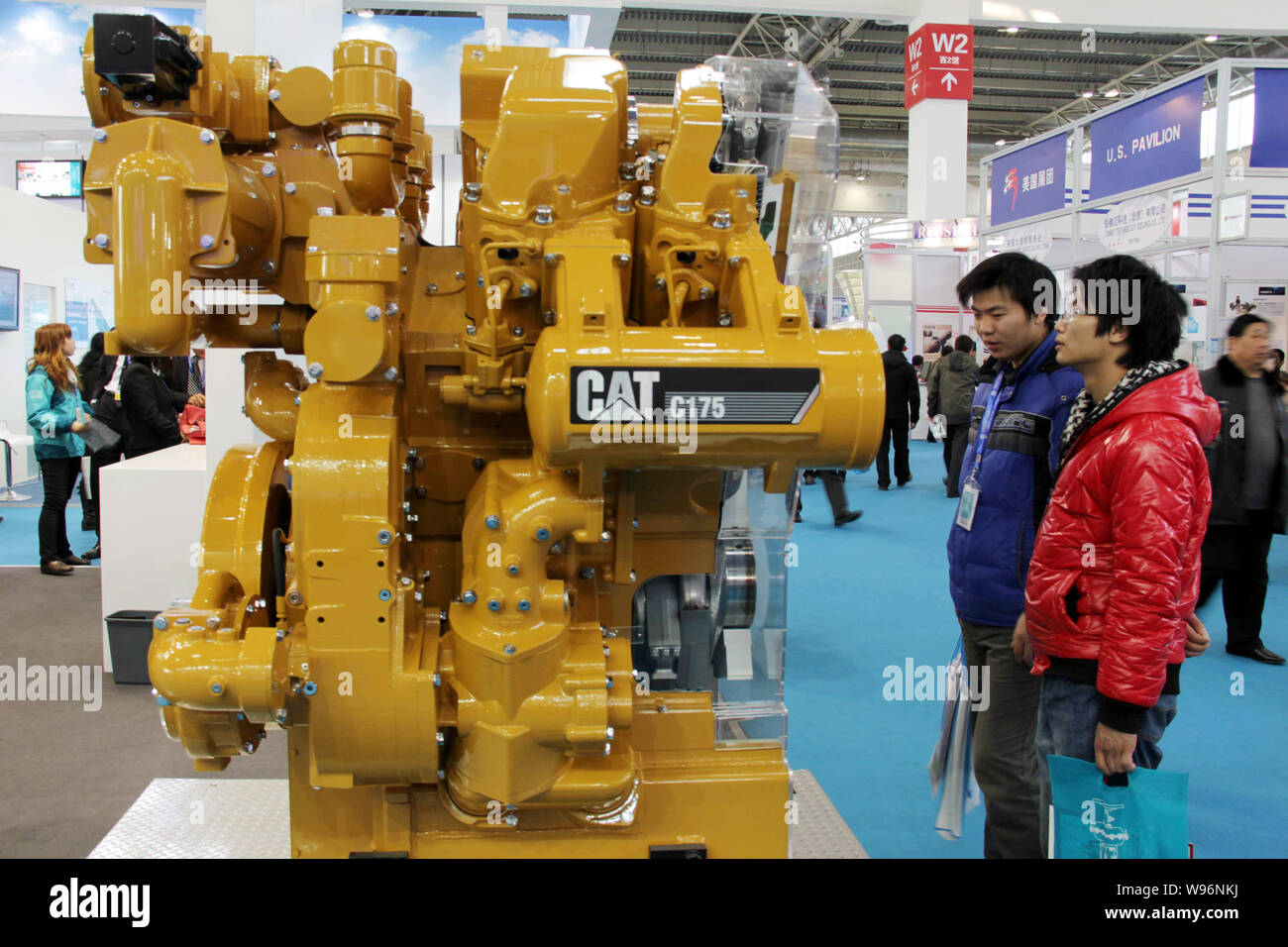 Visitors look at a Caterpillar (CAT) C175 diesel engine during the 12th ...