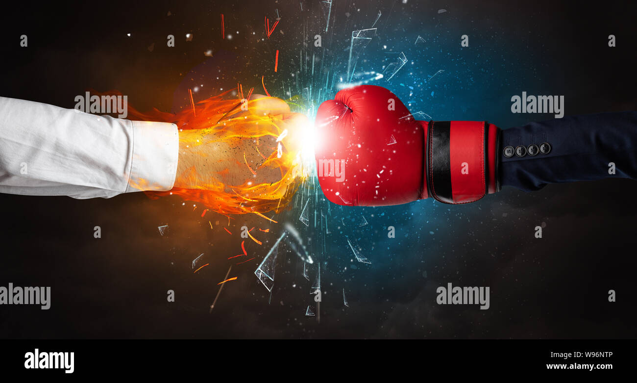 Two hands fighting and breaking glass into small pieces with fire and ...