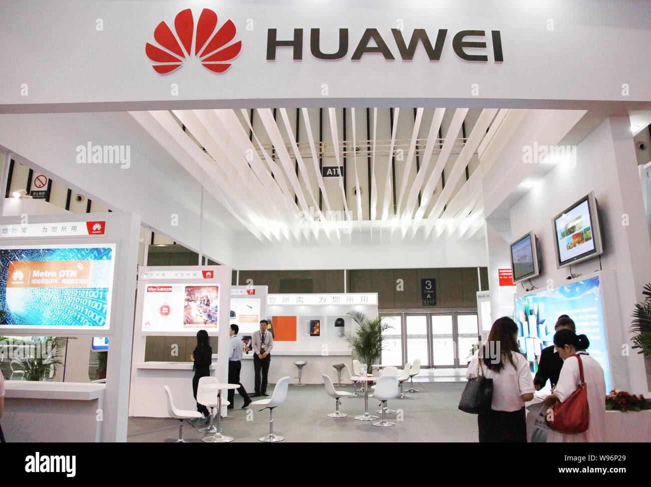 People visit the stand of Huawei during a software expo in Nanjing city ...