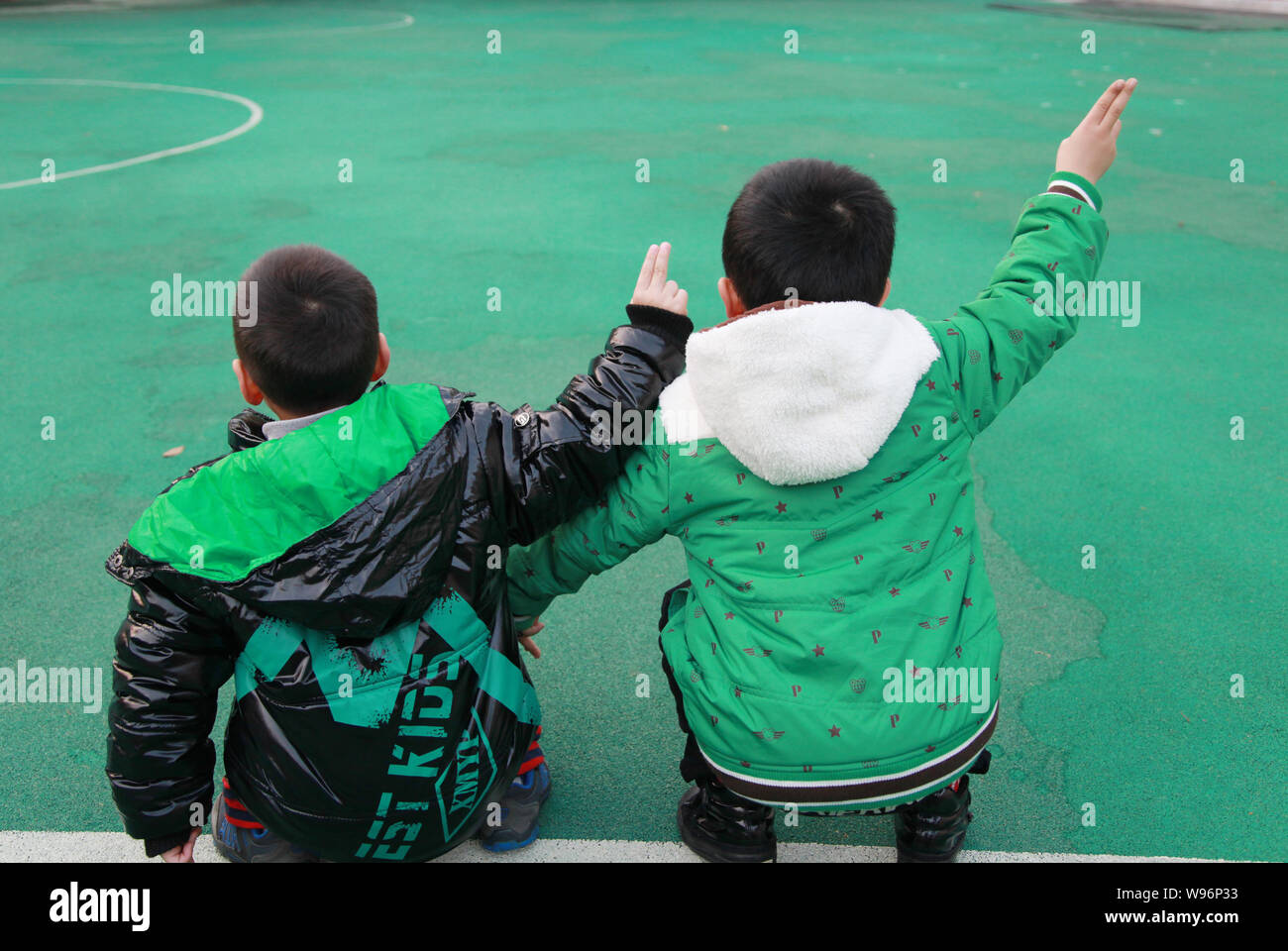 Two young Chinese boys mimic the hand signals of flight deck crew ...