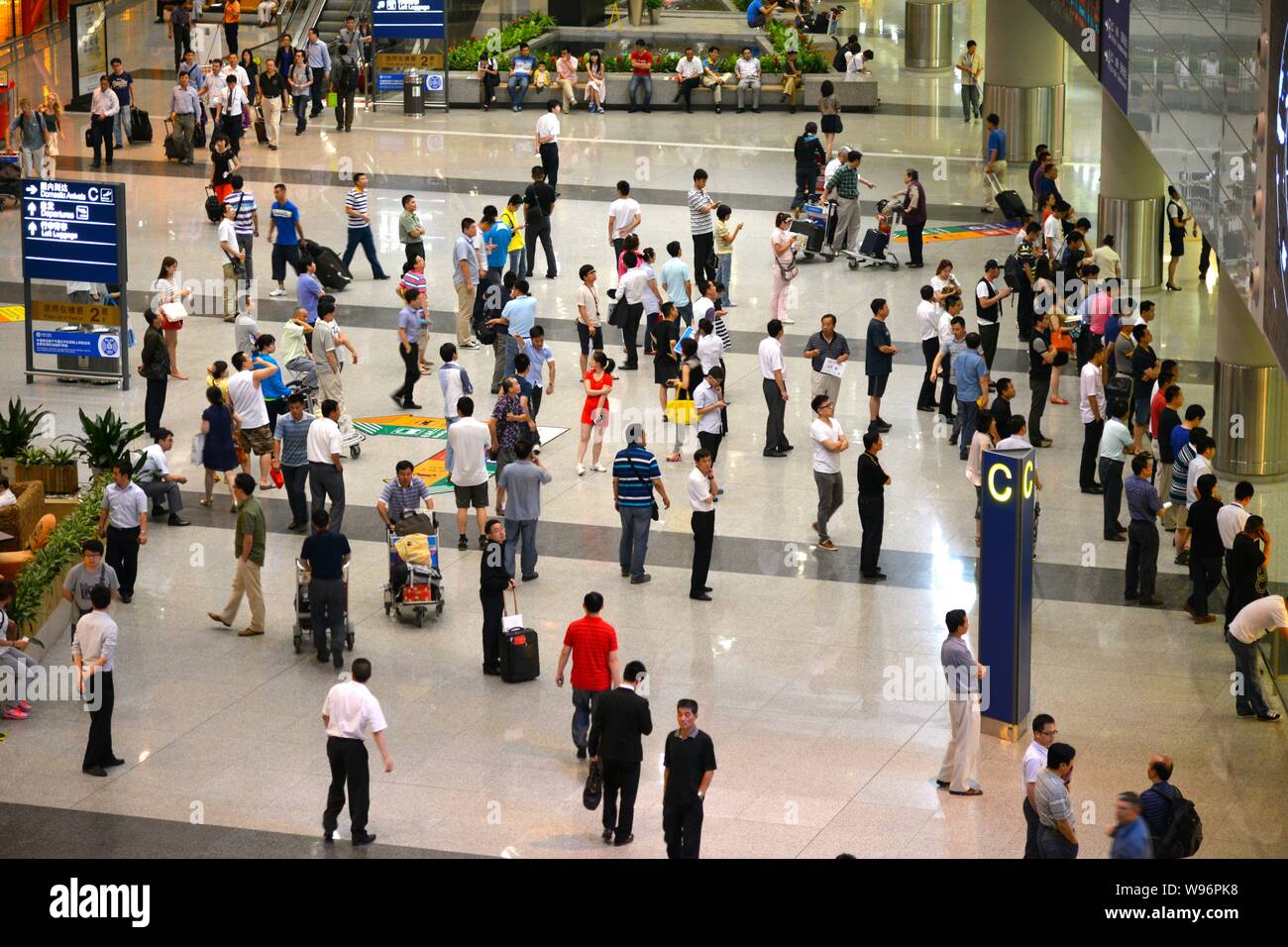 --File--Passengers crowd the Beijing Capital International Airport in ...