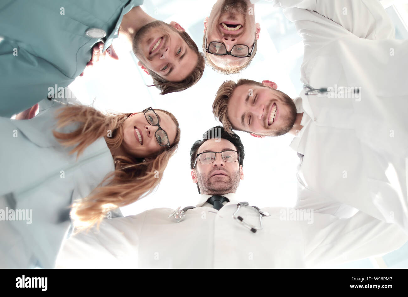 doctors looking down smiling at the camera Stock Photo - Alamy