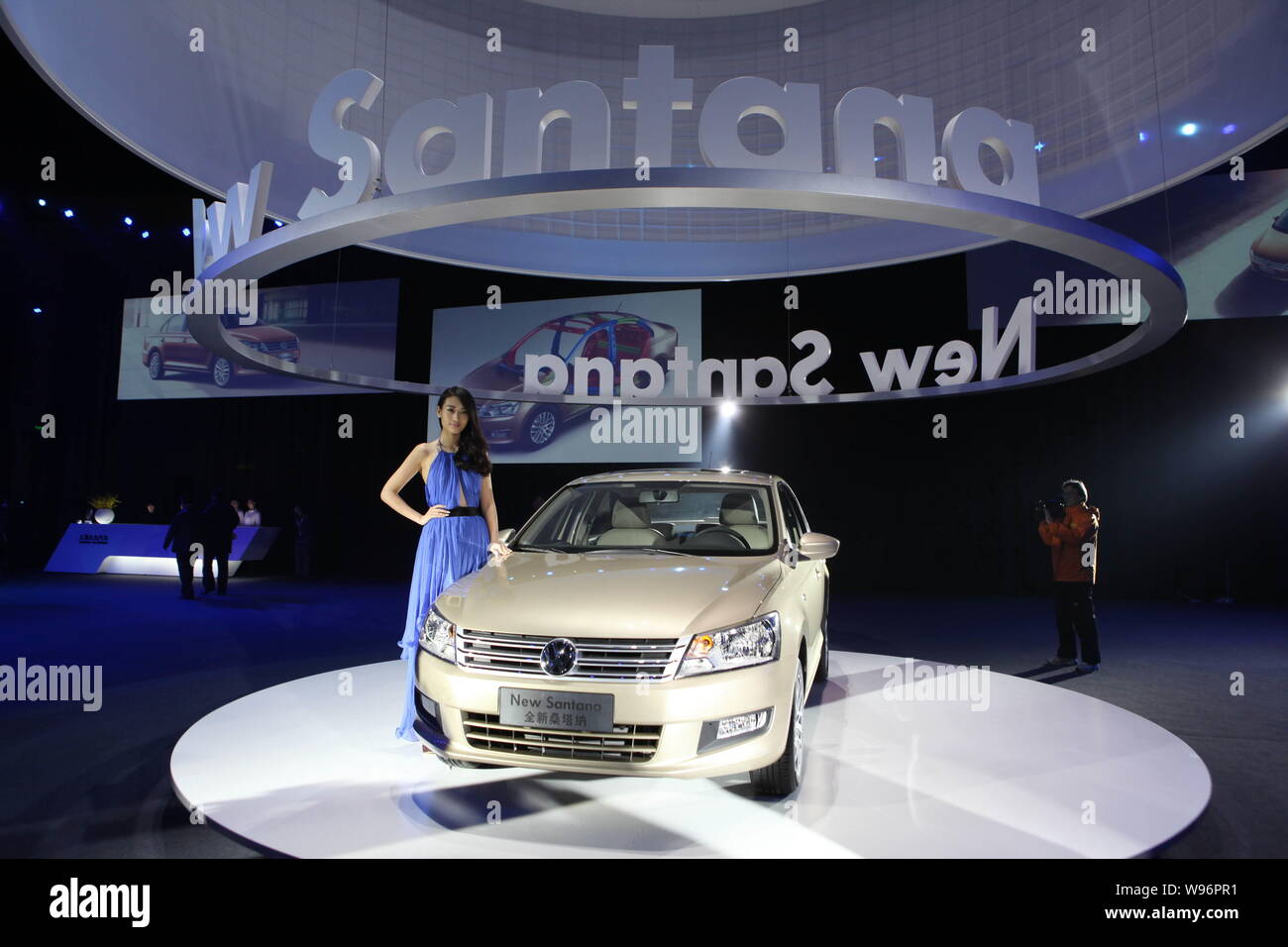 A model poses with the new Santana car at the stand of National Stadium ...