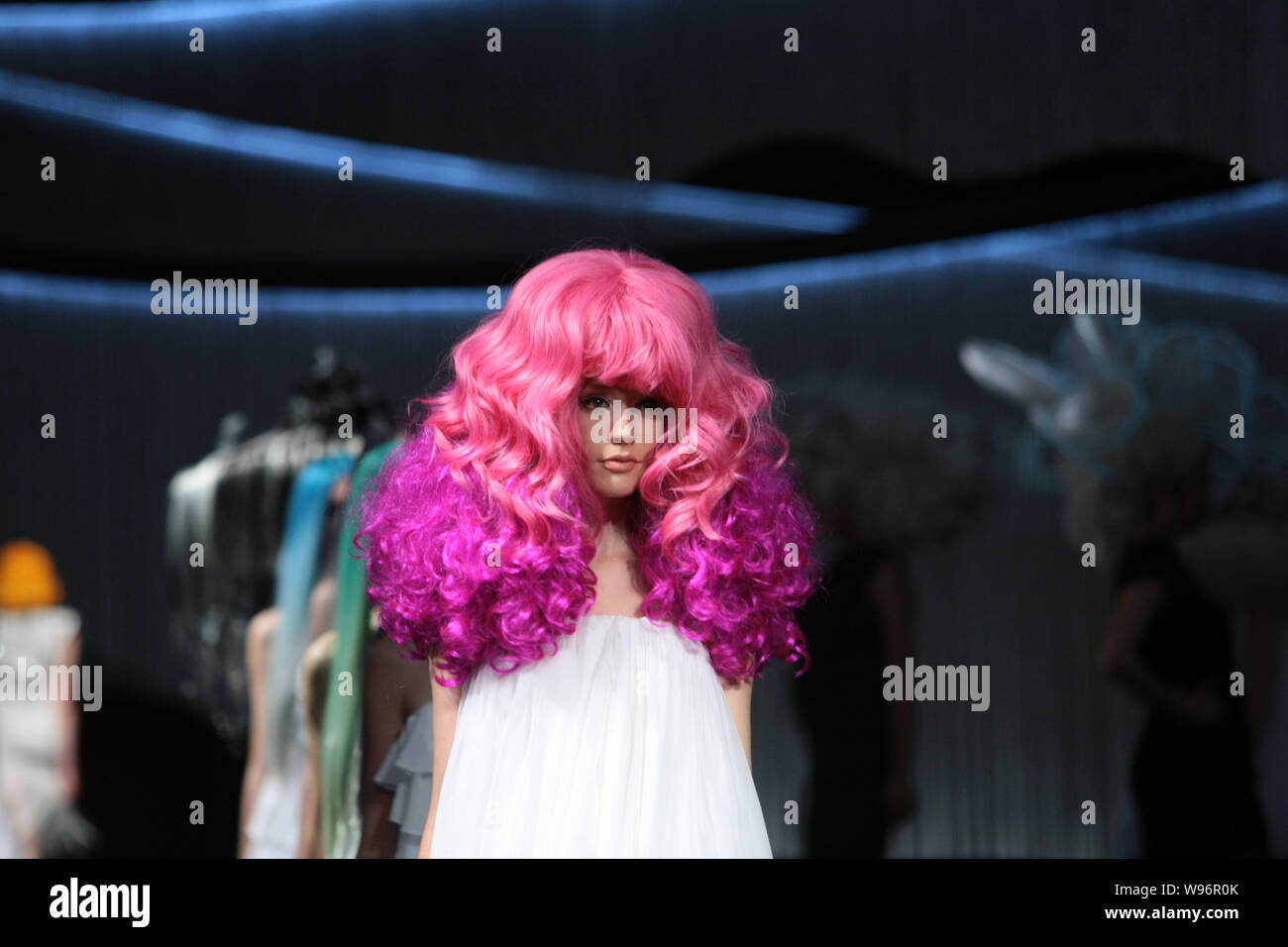 A model presents a new creation during the Rebecca 2013 wig trends ...