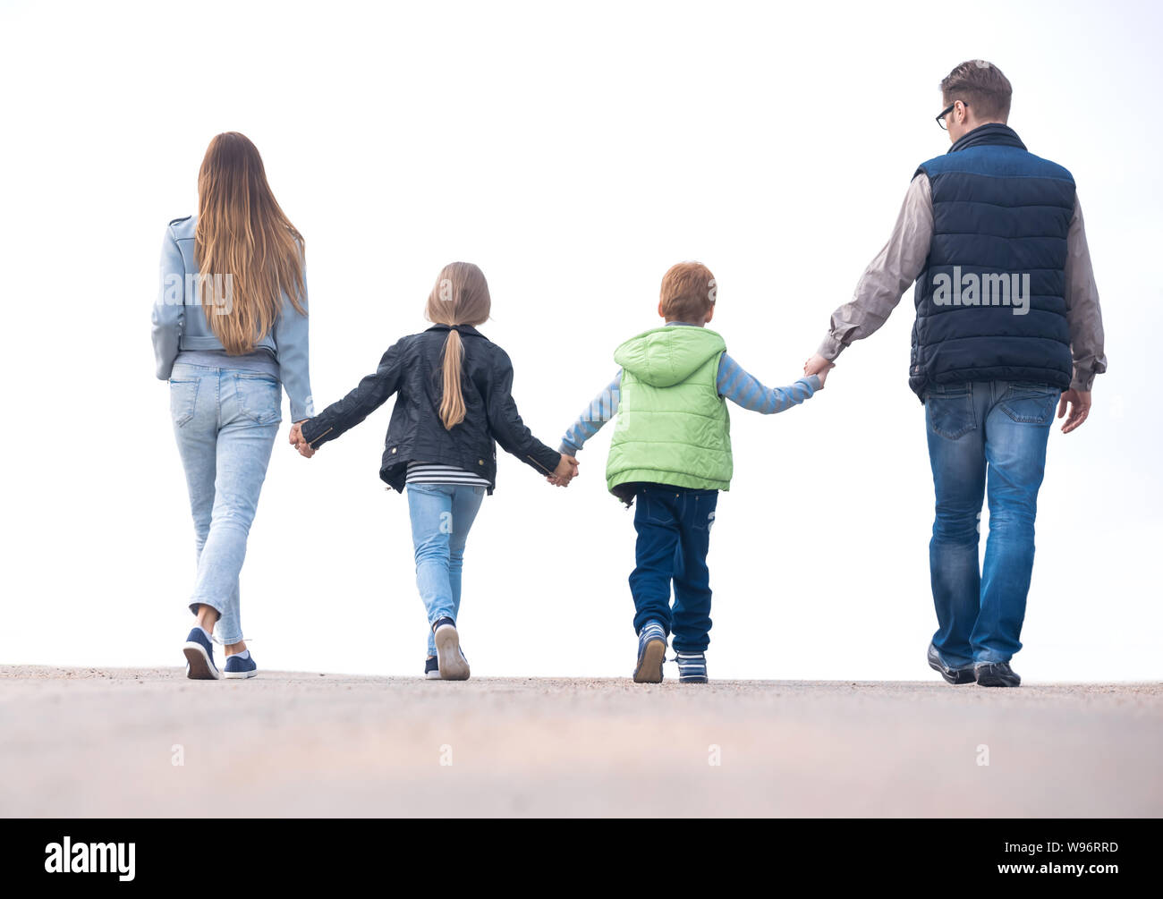 rear view . a happy family goes forward Stock Photo - Alamy