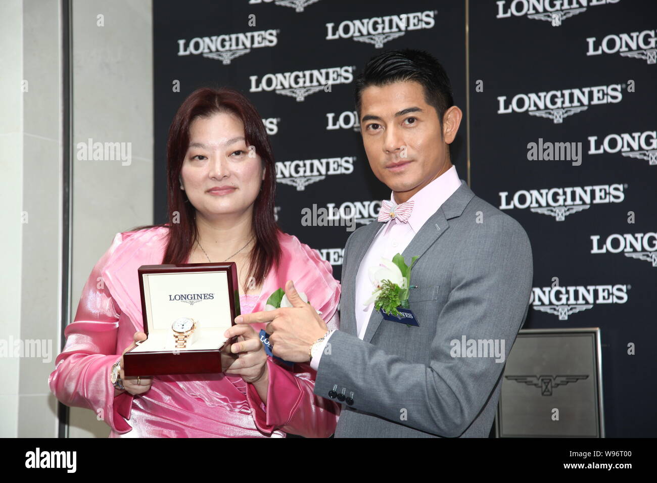 Hong Kong singer and actor Aaron Kwok, right, poses at the opening ...