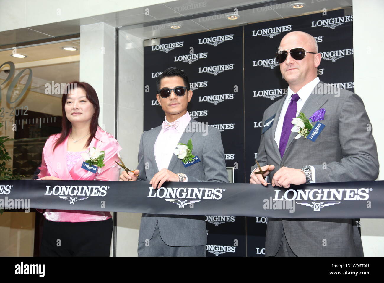 Hong Kong singer and actor Aaron Kwok, center, poses at the opening ...