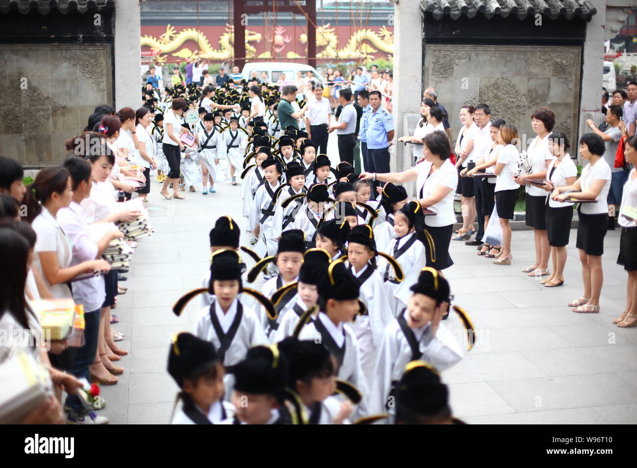 Newly enrolled primary school students, dressed in traditional Chinese ...