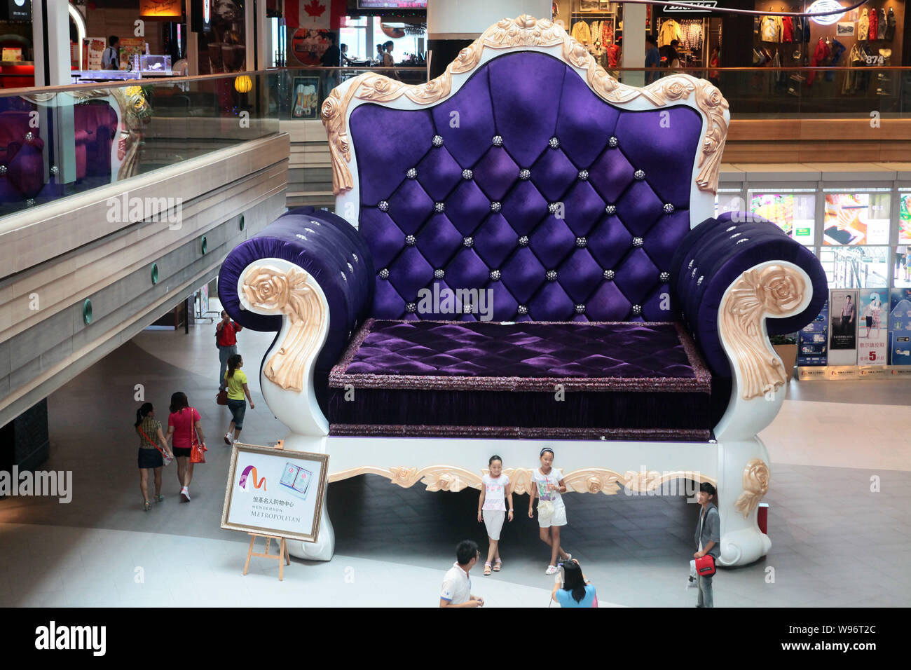 Shoppers pose in front of the worlds biggest sofa at a mall in Shanghai ...