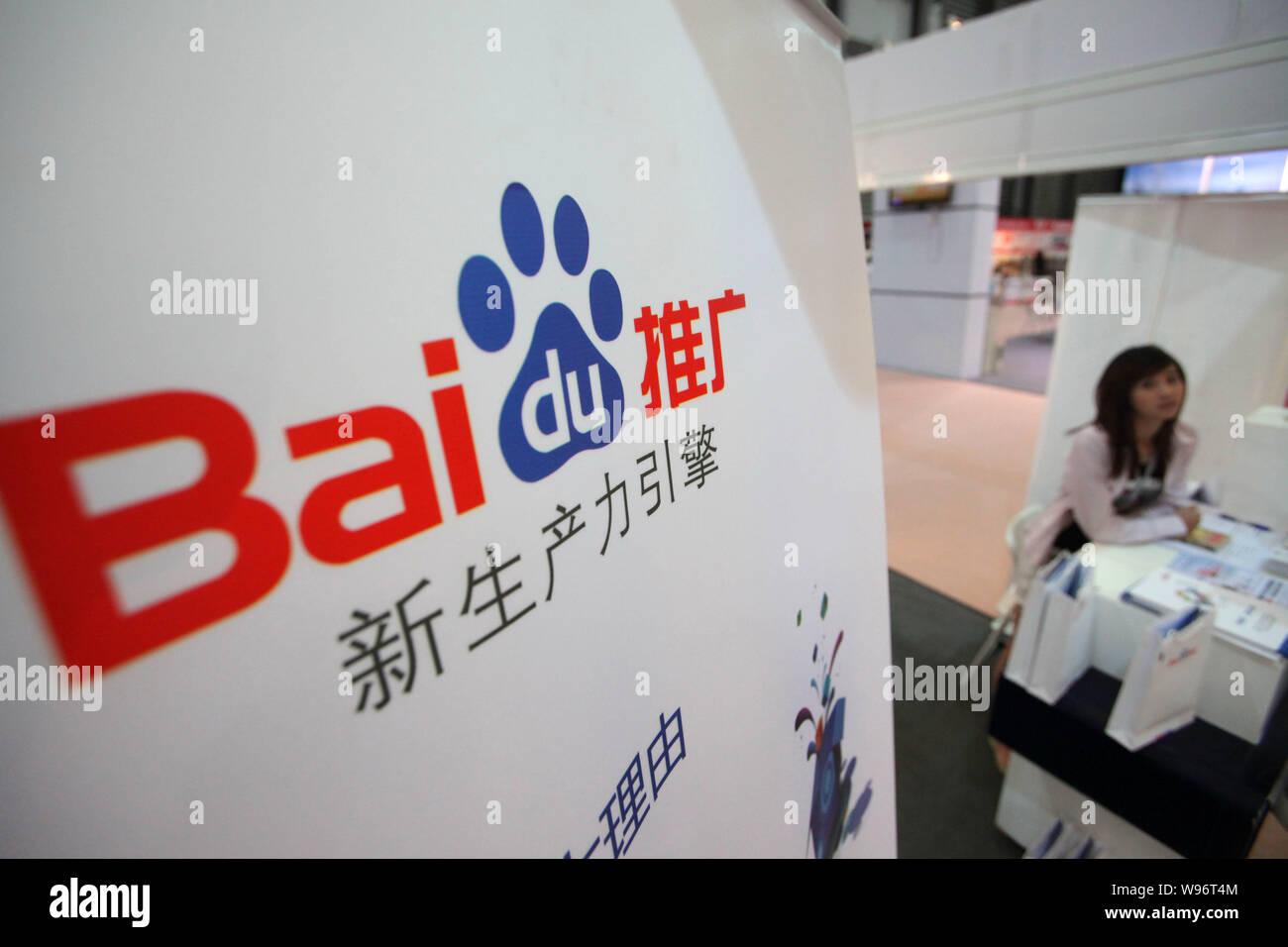 --FILE--A young Chinese woman sits at the stand of Baidu during a fair ...
