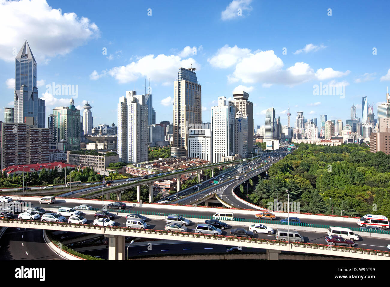 Cars travel on elevated highways against the skyline of Puxi and Pudong ...