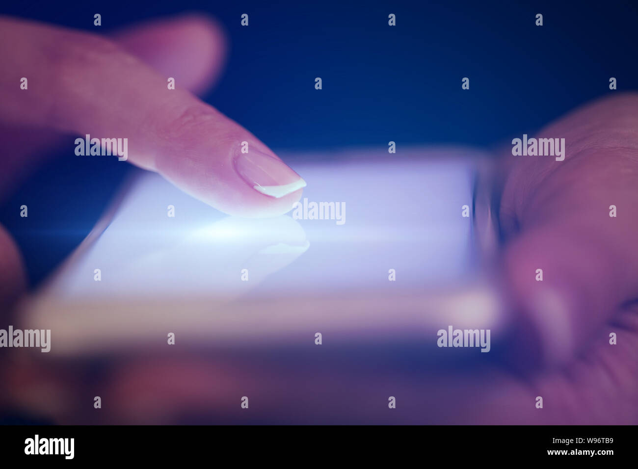 Finger touching phone with dark background with copyspace Stock Photo ...