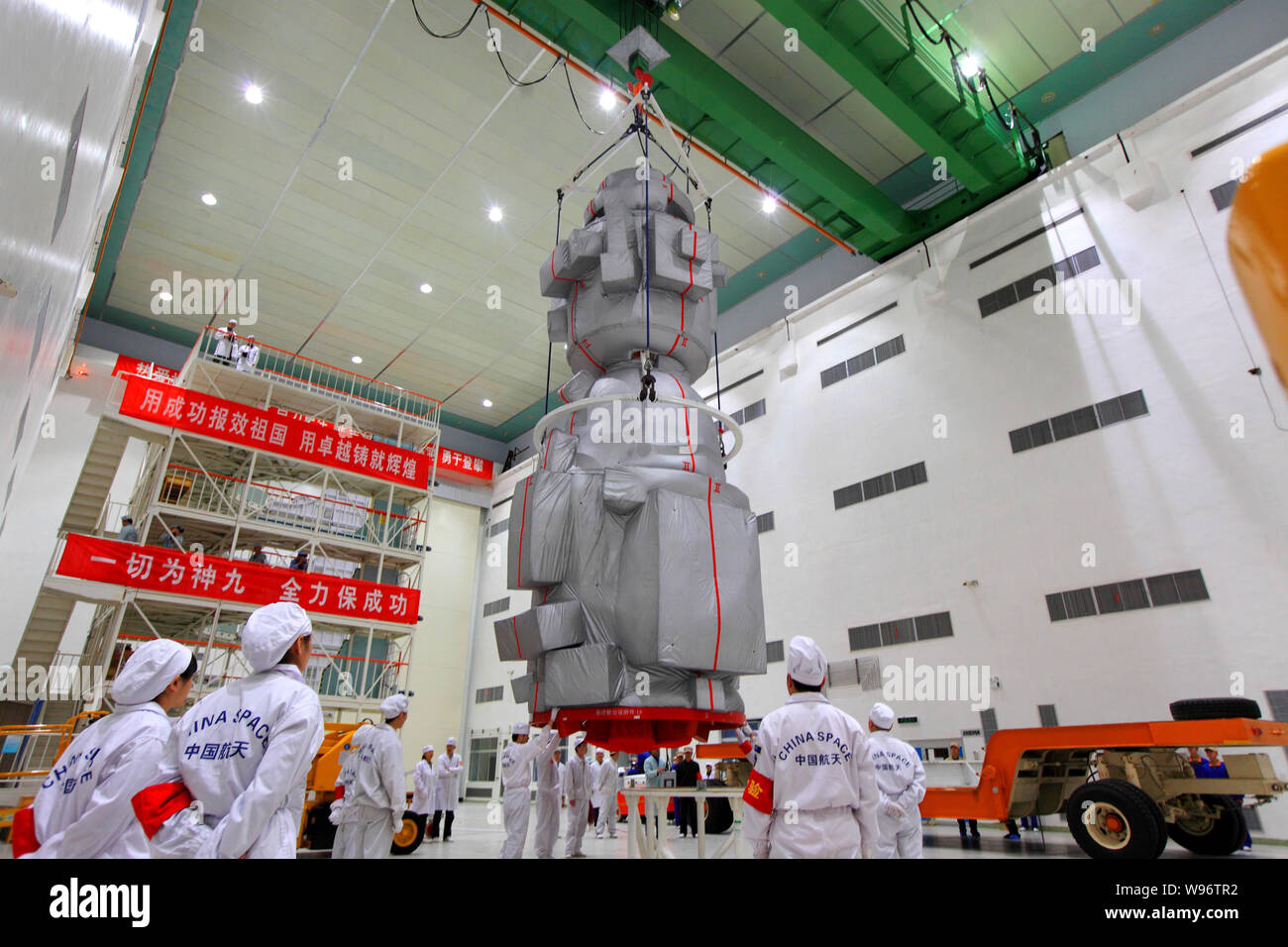 The Shenzhou-9 (Shenzhou IX) spacecraft is being lifted before being ...