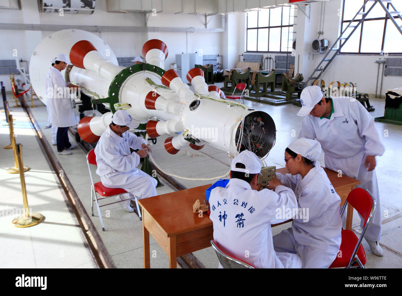 Chinese aerospace engineers check the escape tower of the Shenzhou-9 ...