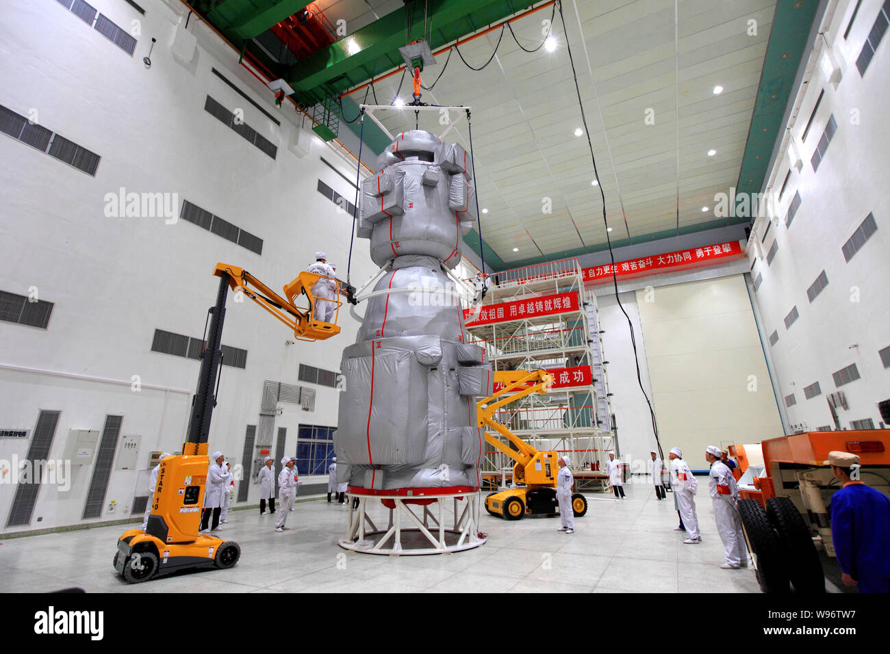 The Shenzhou-9 (Shenzhou IX) spacecraft is being lifted before being ...