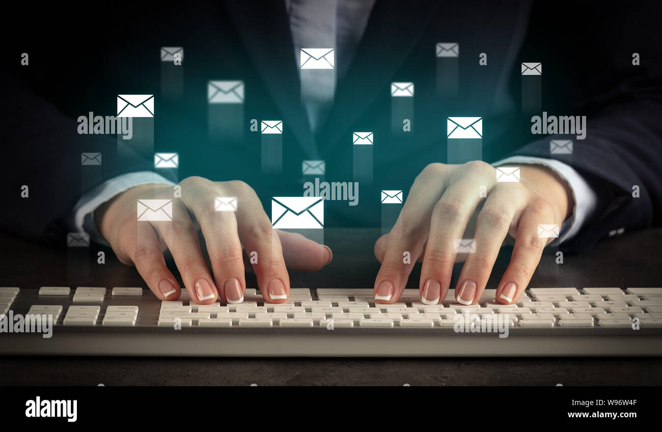 Business woman typing on keyboard with mail icons around Stock Photo ...