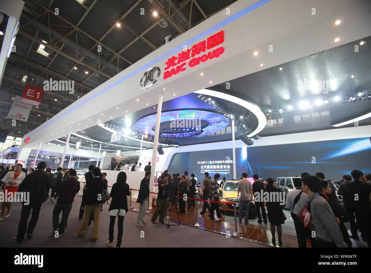 --FILE--Visitors walk past the stand of BAIC Group during the 12th ...