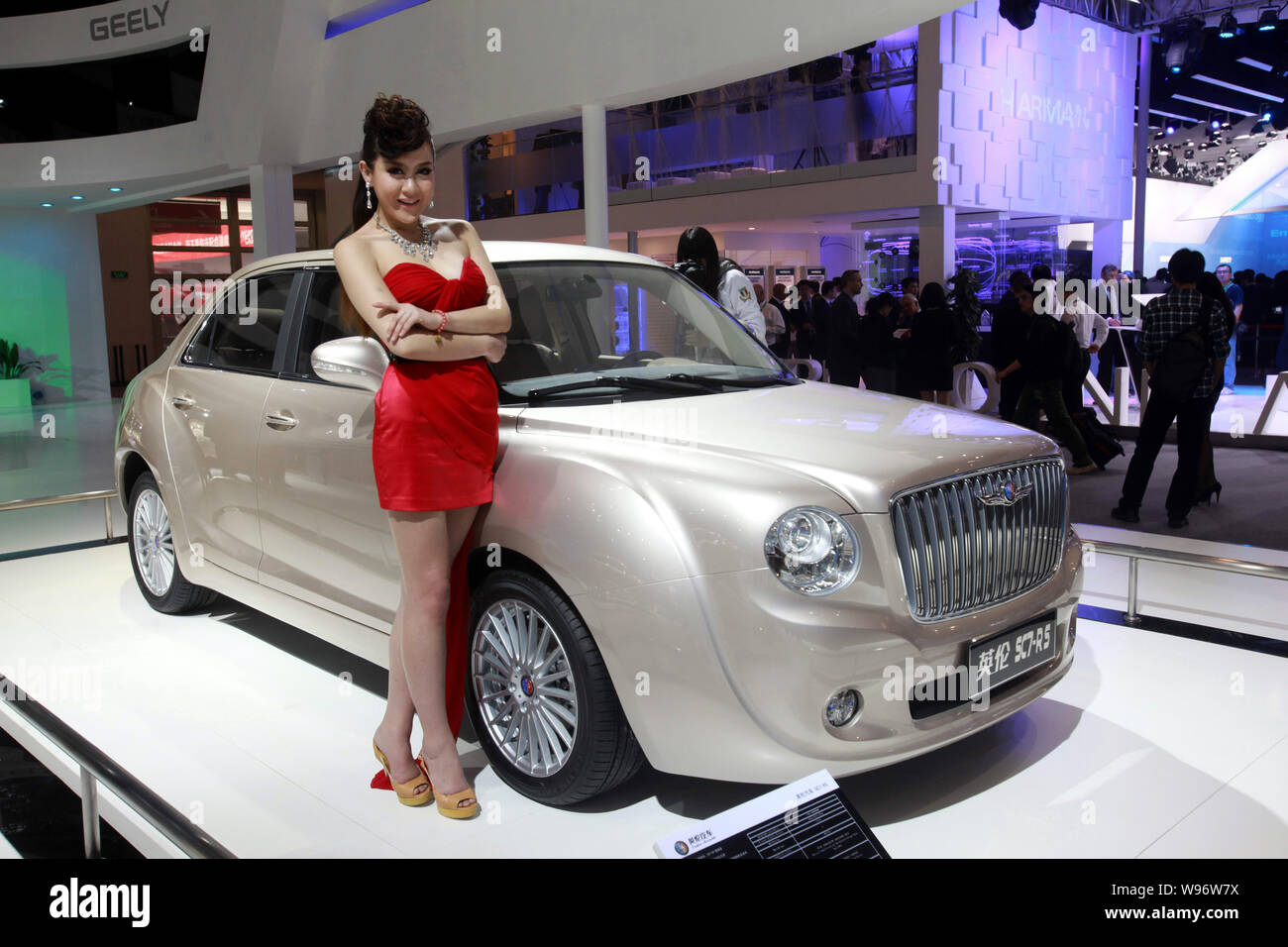 A model poses with a Geely Englon SC7-R5 during the 12th Beijing ...
