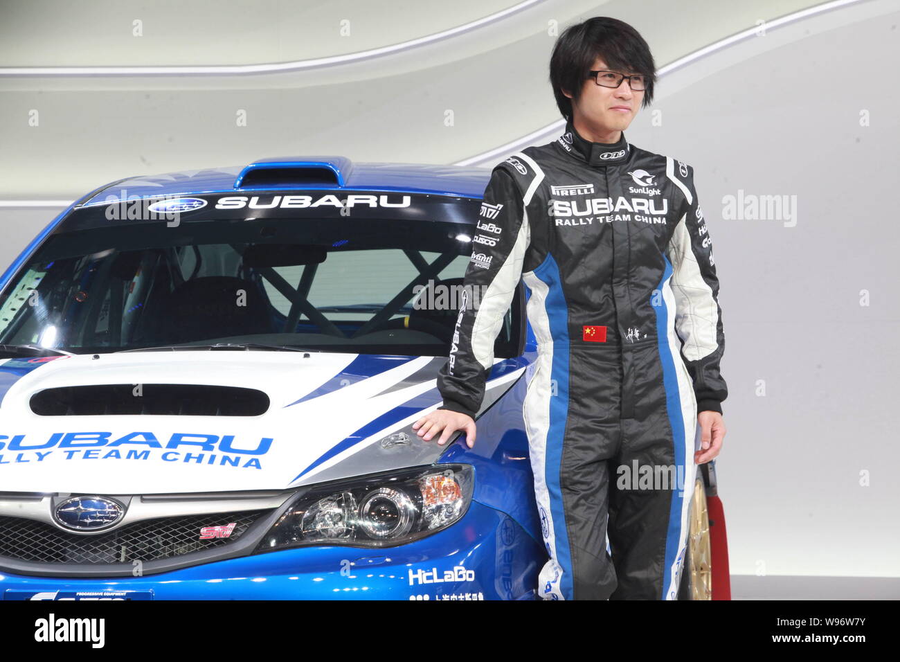 Chinese professional rally driver Han Han poses with a Subaru Cusco ...