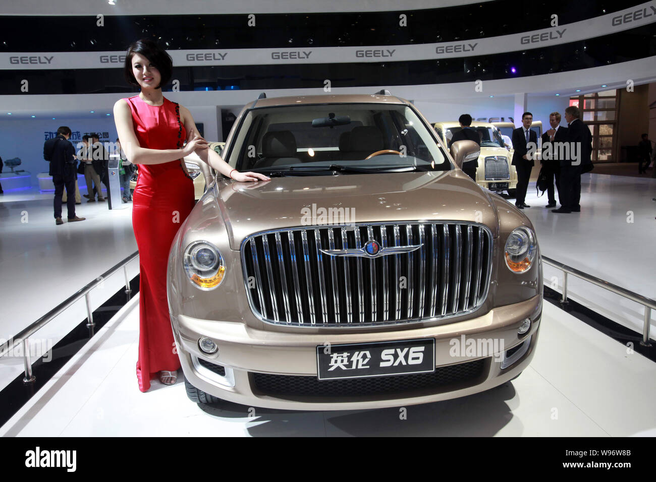 A model poses with a Geely Englon SX6 during the 12th Beijing ...