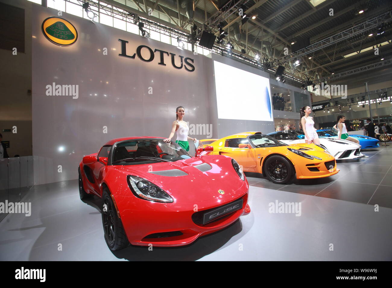 Models pose with Lotus NYO roadsters during the 12th Beijing ...