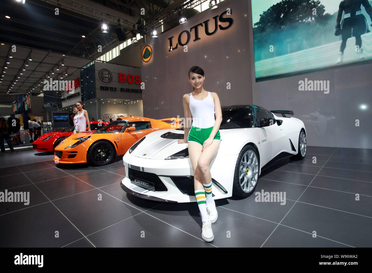 Models pose with Lotus NYO roadsters during the 12th Beijing ...