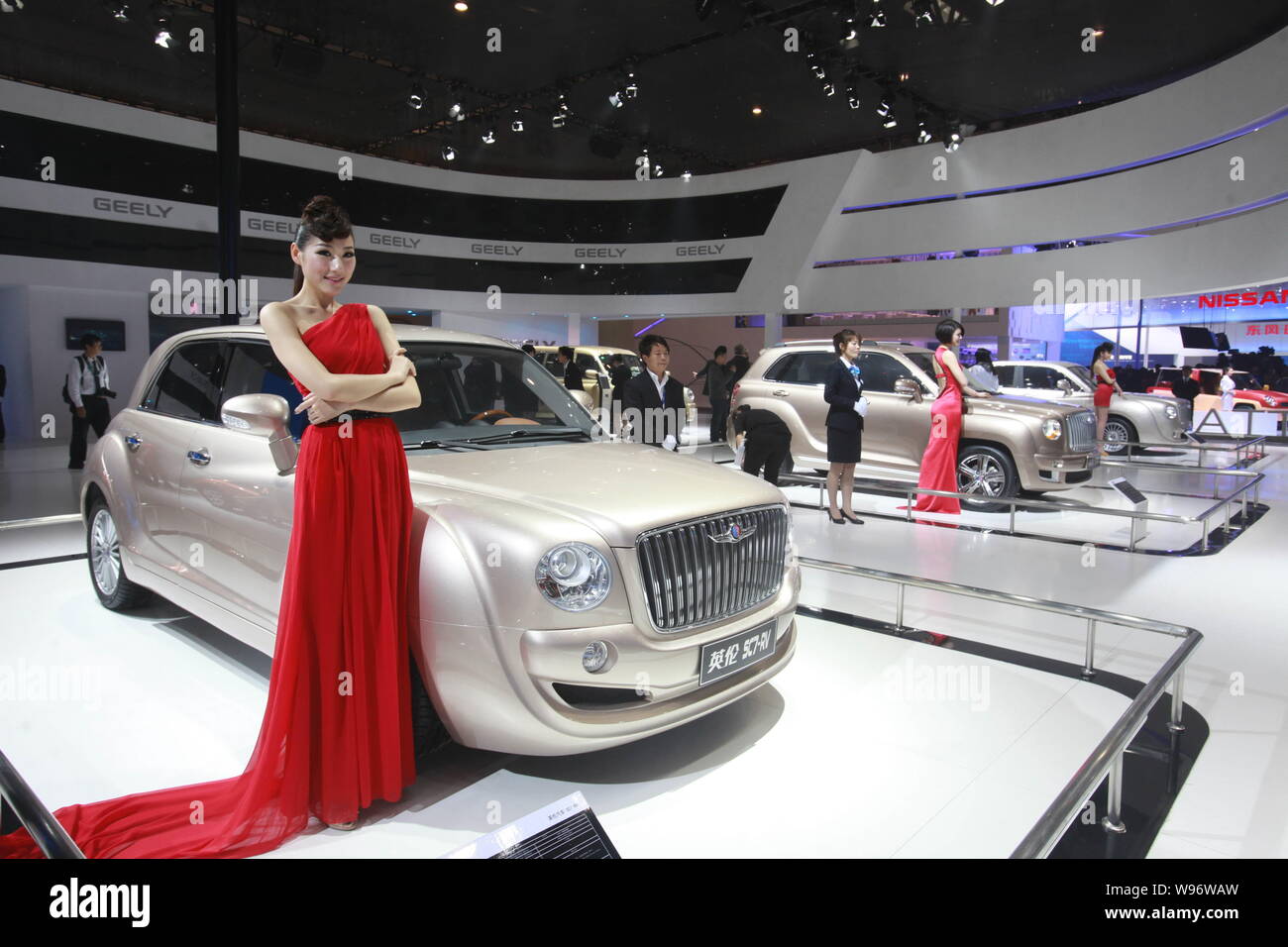 --File--Models pose with Geely cars during the 12th Beijing ...