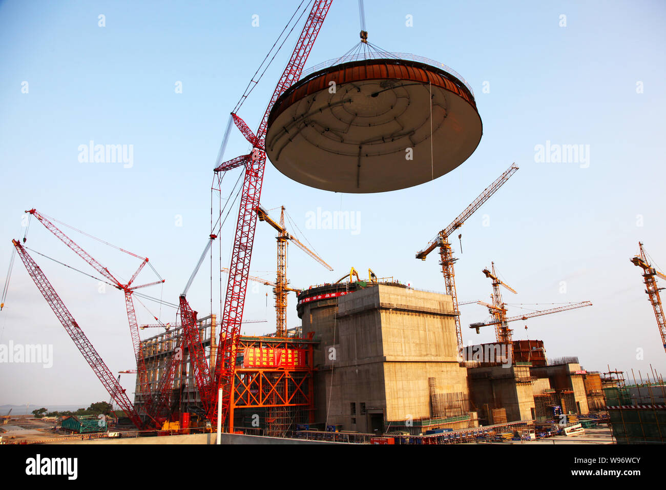 A dome is being hoisted on to the containment structure for the No.1 ...