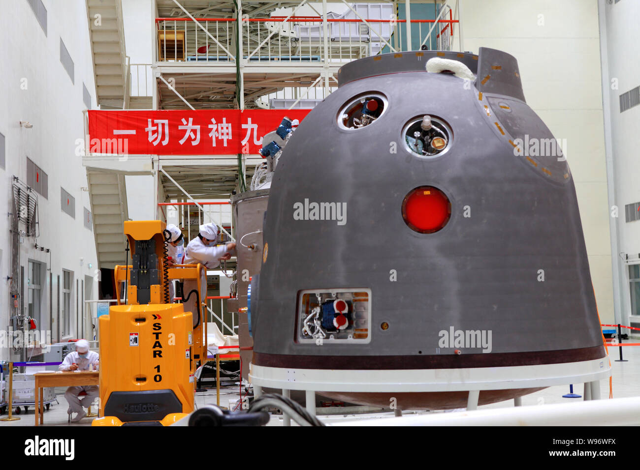 Chinese aerospace engineers check the orbital and re-entry modules of ...