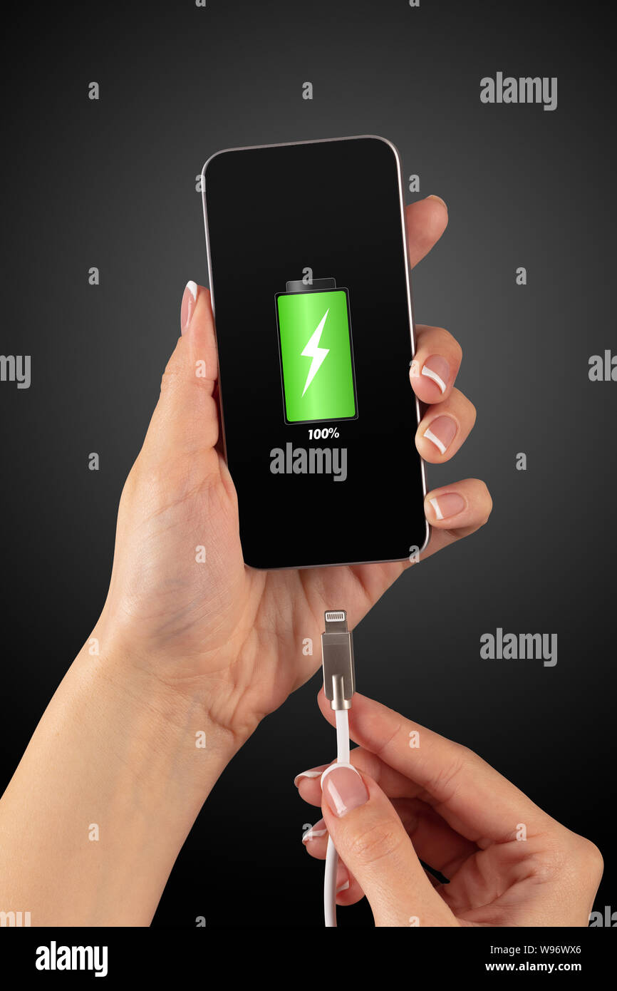 Elegant hand charging cellphone with low battery Stock Photo - Alamy
