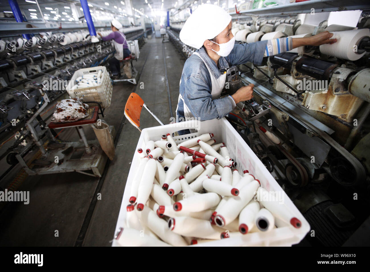 --FILE--Female Chinese workers handle the production of yarn to be exported to southeast Asian ...