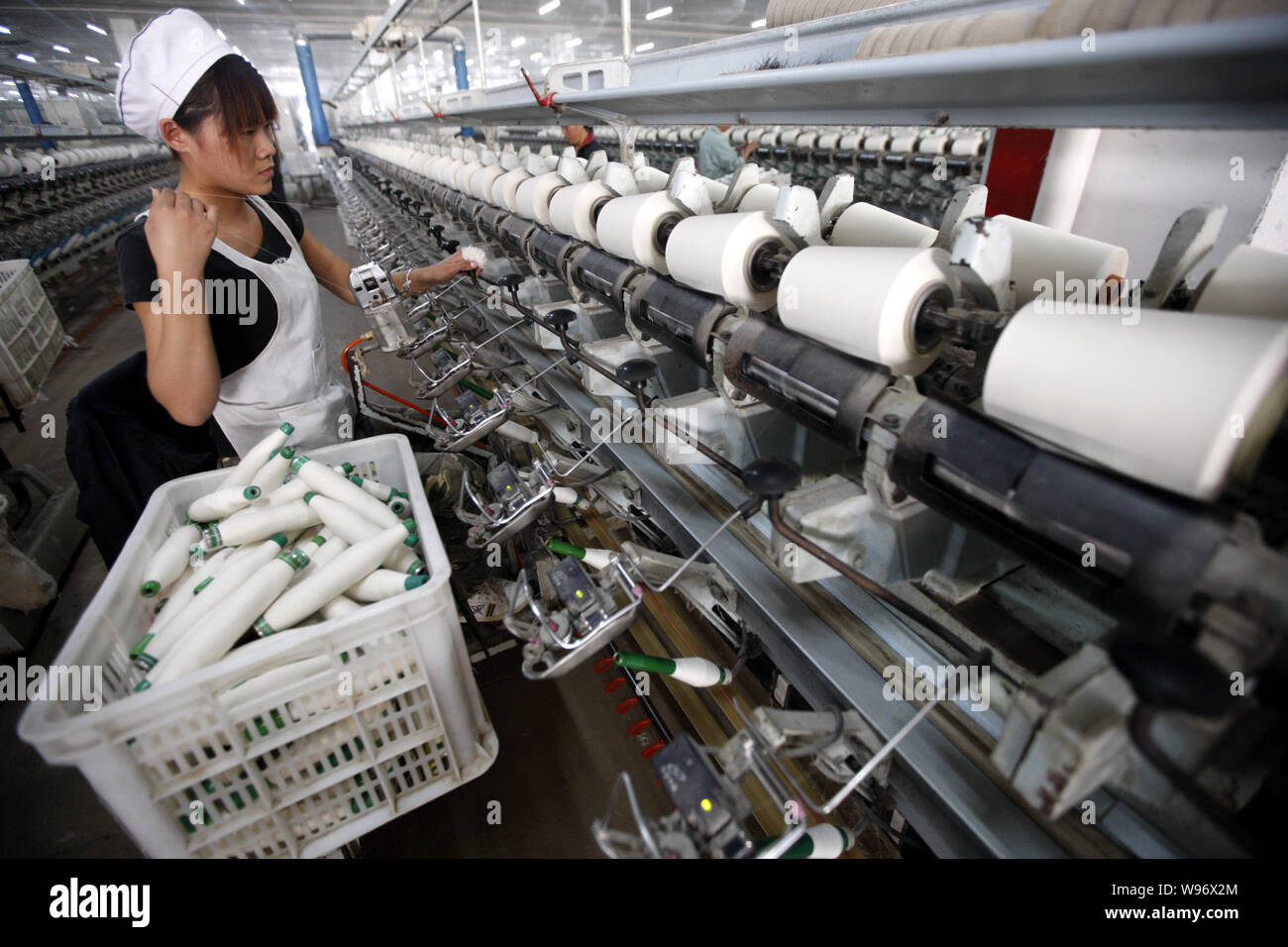 --FILE--Female Chinese workers handle the production of yarn to be exported to southeast Asian ...