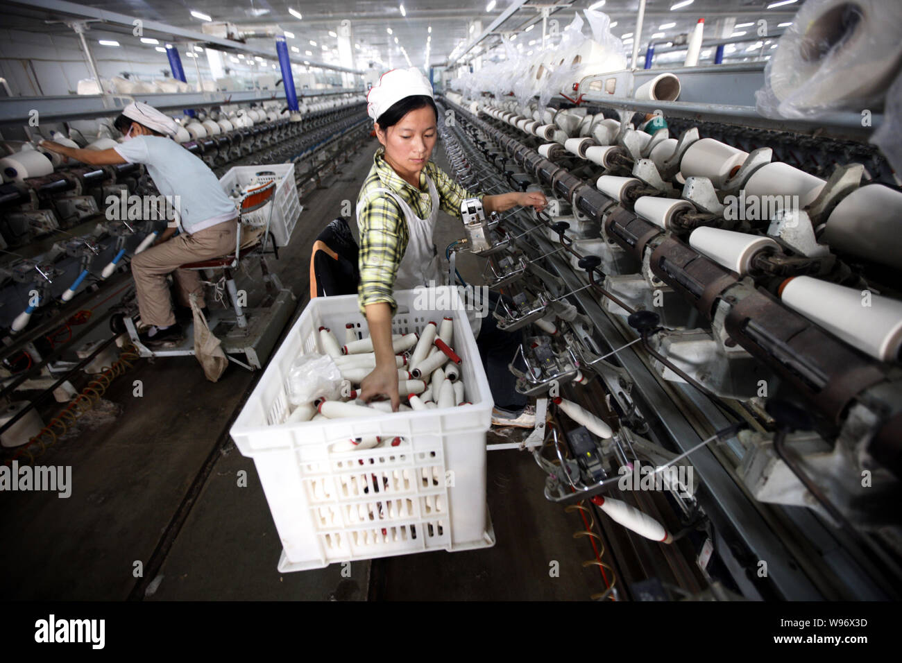 --FILE--Female Chinese workers handle the production of yarn to be exported to southeast Asian ...