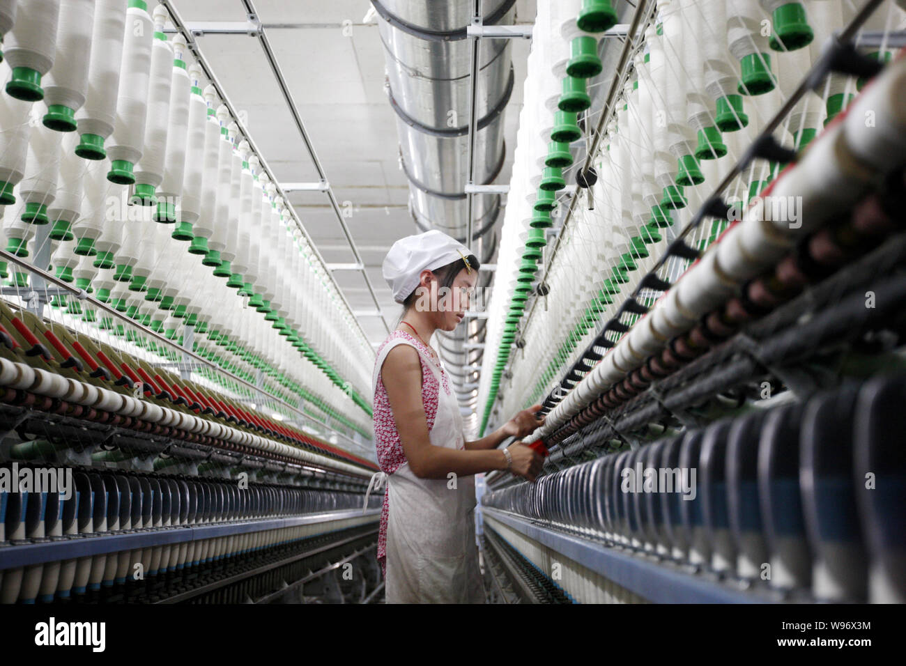 --FILE--A female Chinese worker handles the production of yarn to be exported to southeast Asian ...