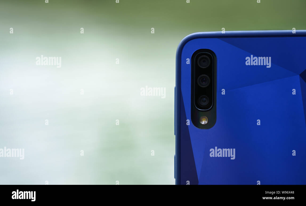 Smartphone back triple camera with blurry copy space Stock Photo - Alamy