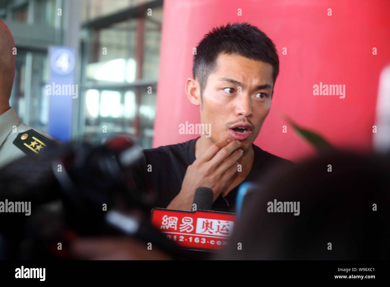 Chinese Olympic badminton champion Lin Dan (black) is pictured at the ...