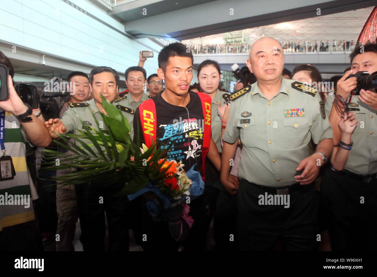 Chinese Olympic badminton champion Lin Dan (black) is pictured at the ...