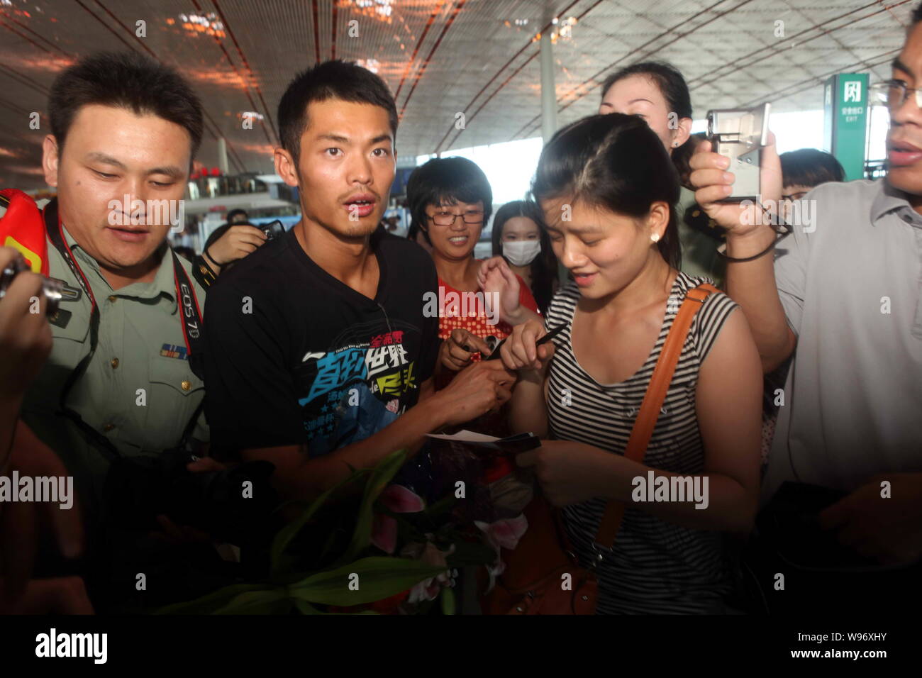 Chinese Olympic badminton champion Lin Dan (black) is pictured at the ...
