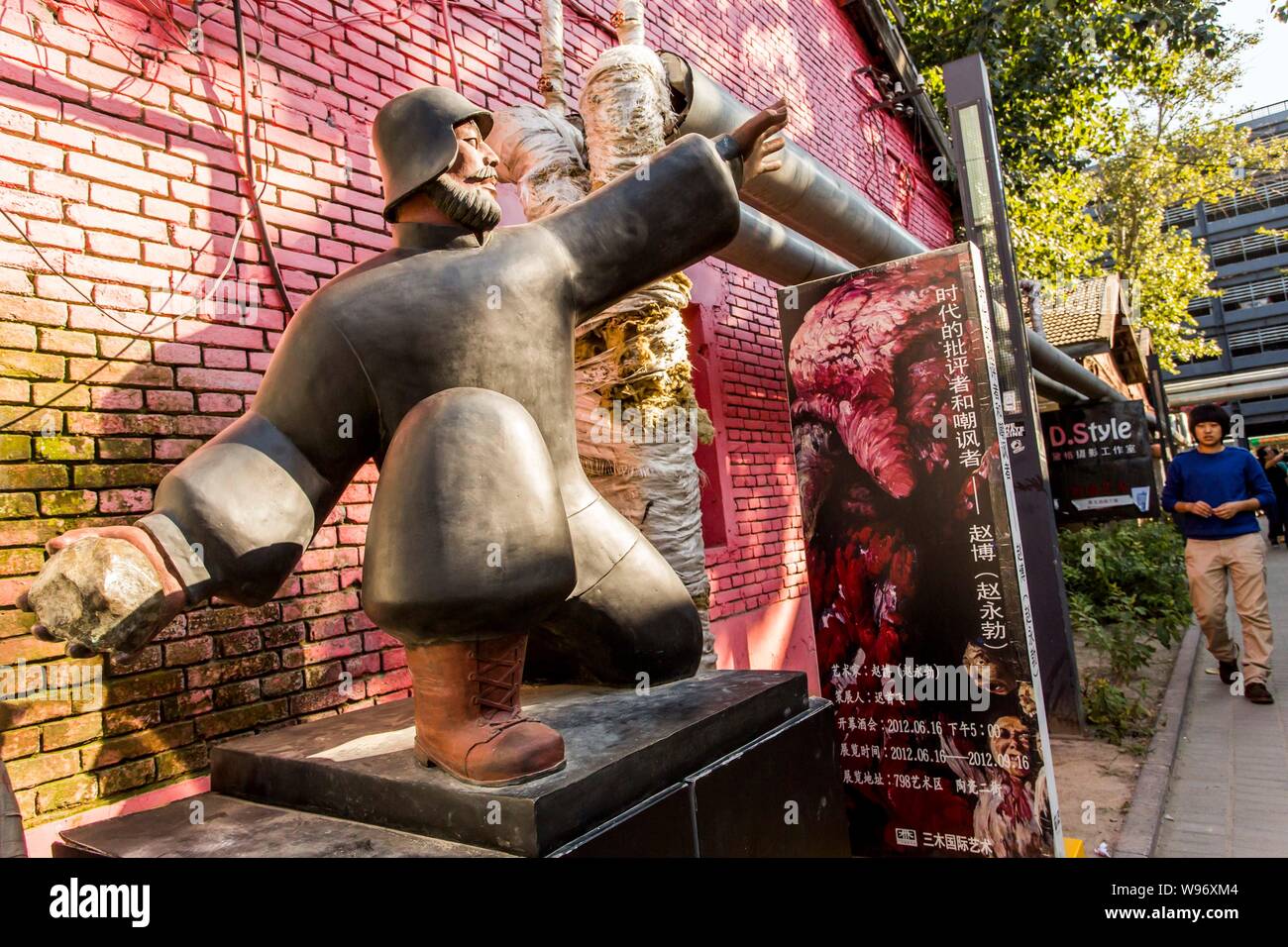 --FILE--Visitors take photo in front of a Logo at the Beijing 798 Art ...