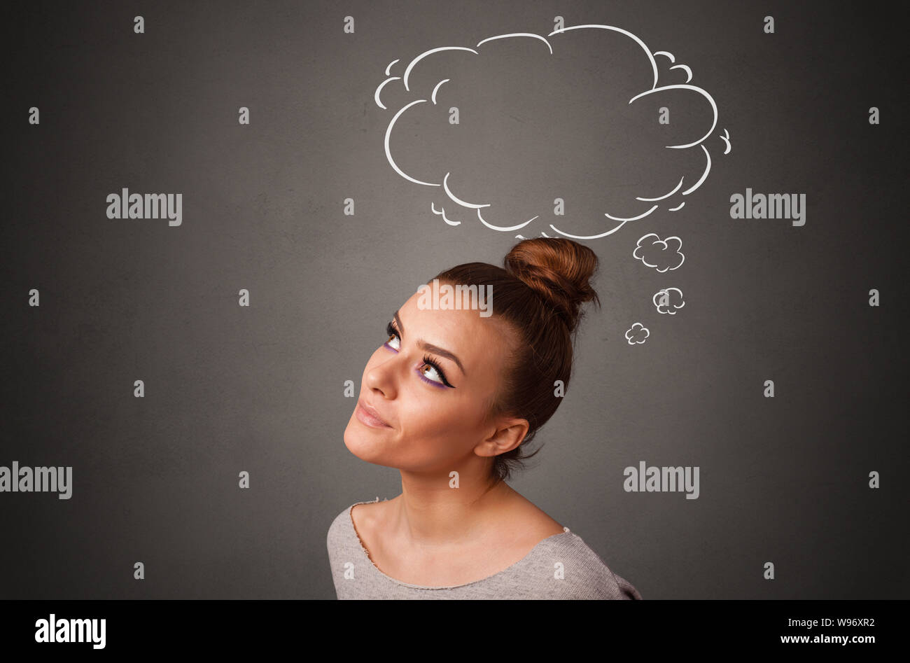 Pretty girl thinking with speech bubble above her head Stock Photo - Alamy