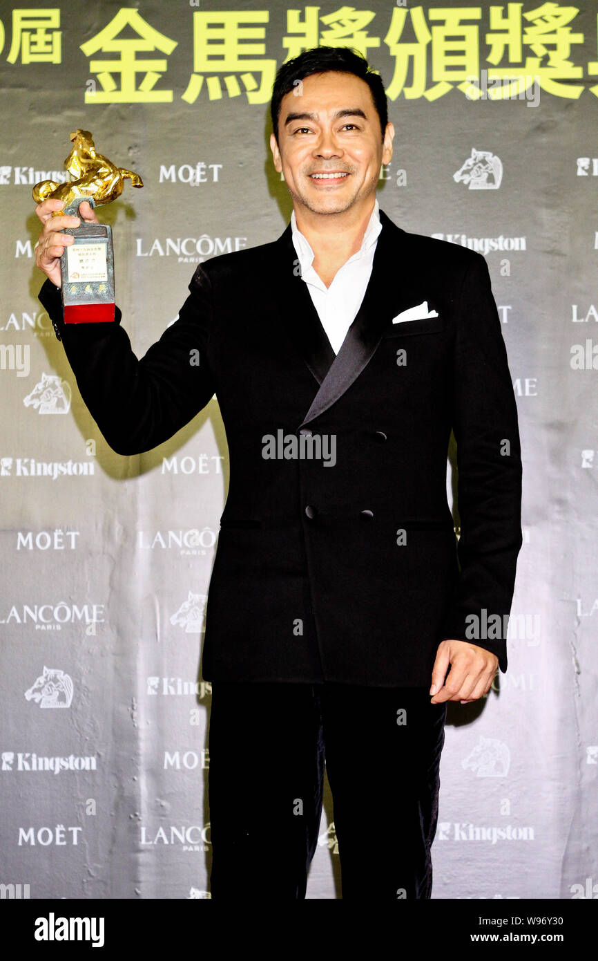Hong Kong actor Lau Ching-wan (or Sean Andy) poses with his award for ...
