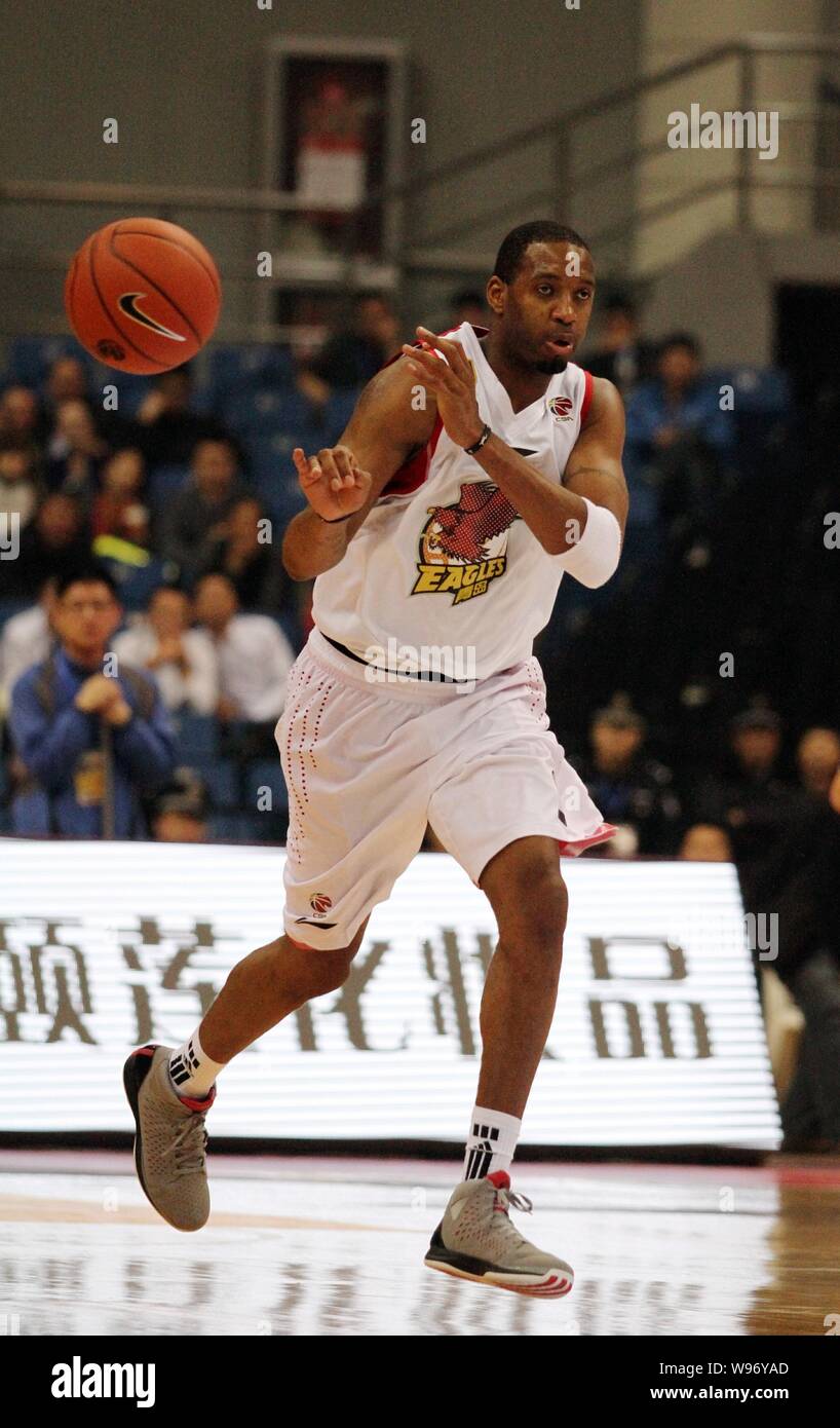 Tracy McGrady of the Qingdao Eagles passes the ball to his teammate ...