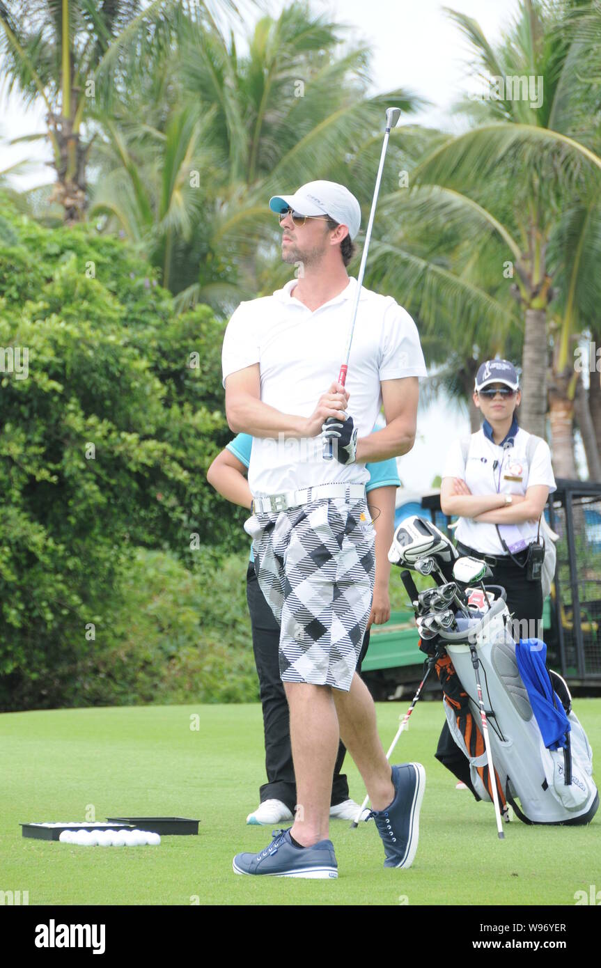 US Olympic swimming champion Michael Phelps looks as he plays a shot ...